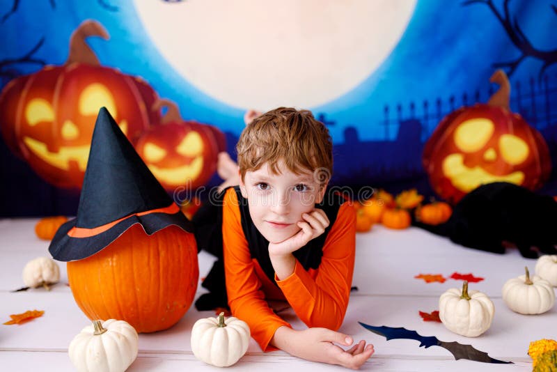 Halloween Concept. Smiling Kid with Pumpkins on Halloween Spooky ...