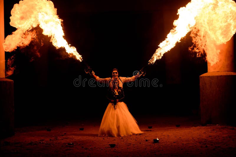 Halloween Couple Standing with Flamethrower in Hands. Big Fire Stock ...