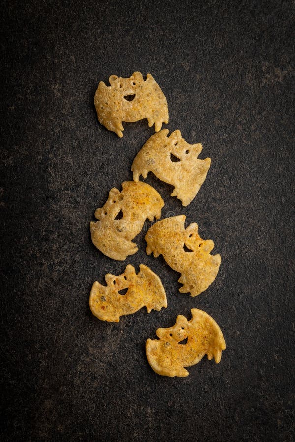 Halloween Crispy Bat Shaped Chips on Dark Table Stock Image - Image of ...