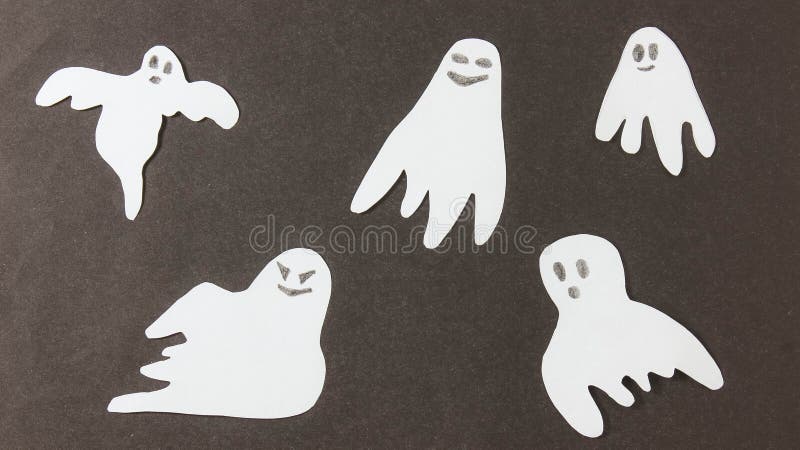 Halloween. a Few Paper Ghosts on a Black Paper Surface Stock Image ...
