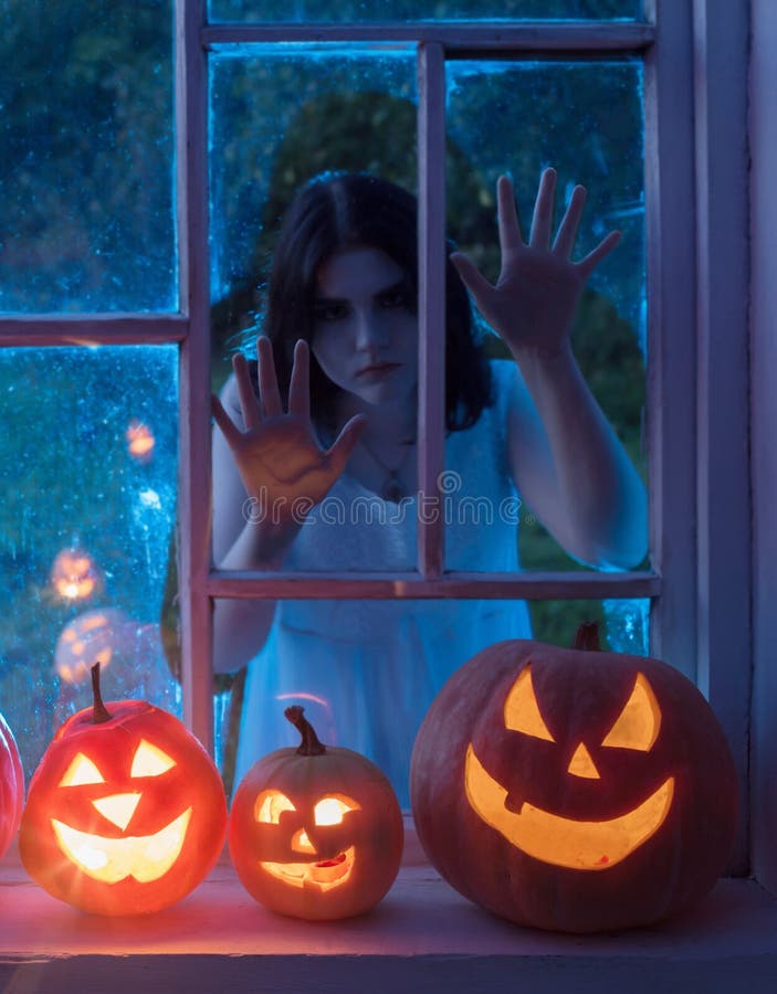 Halloween Pumpins on Windowsill with Ghost Outside Window Stock Image ...