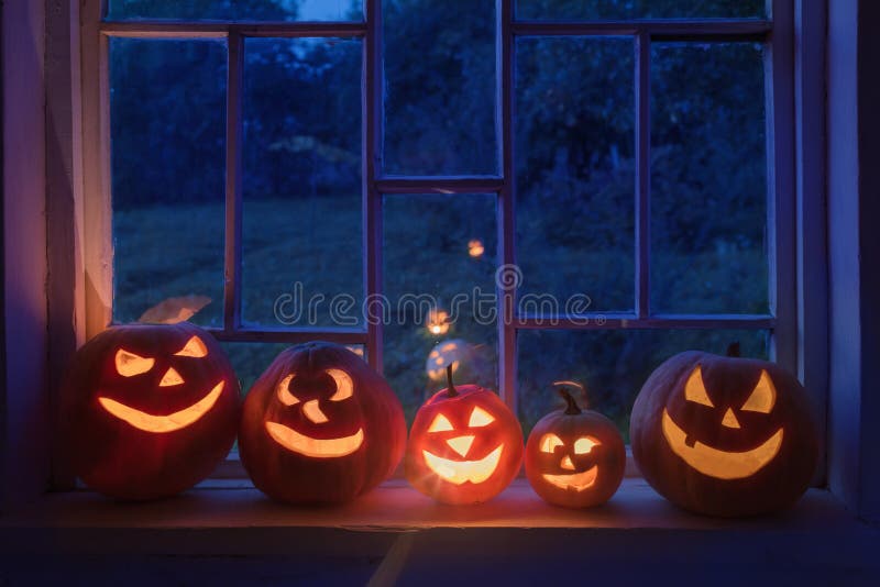Halloween Pumpins on Windowsill with Ghost Outside Window Stock Image ...