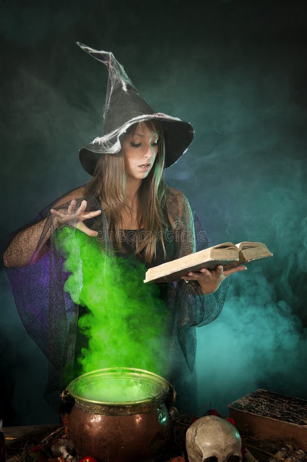 Halloween Witch Cooking a Potion in a Cauldron Stock Photo - Image of ...