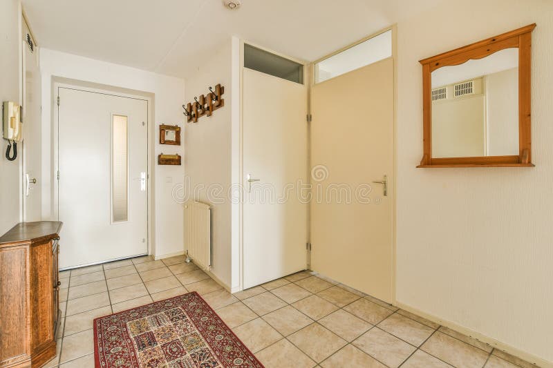 A Hallway with Doors and a Rug and a Mirror Editorial Stock Image ...