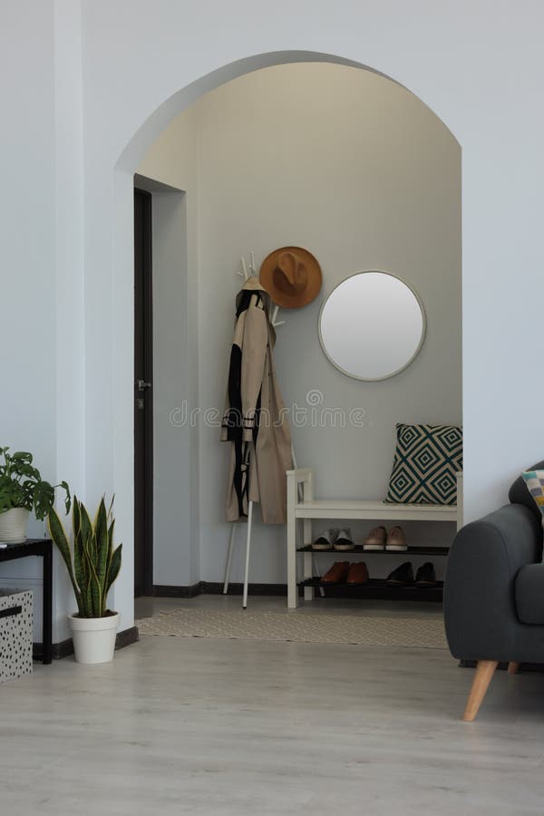Hallway Interior with Clothes Rack and Round Mirror Stock Image - Image ...