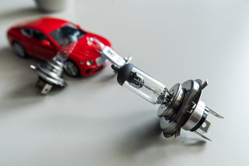 Halogen H7 Car Headlight Bulb with Small Red Toy Car on White Desk ...