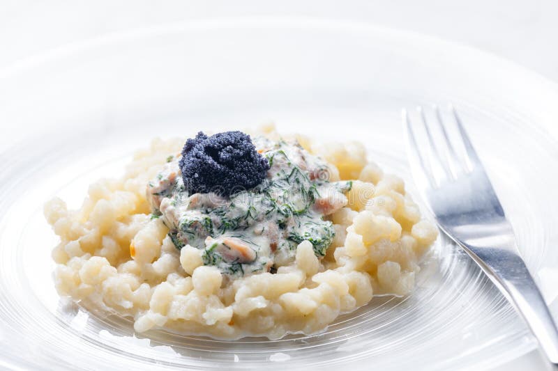 Halusky with Salmon and Dill Sauce Served with Black Caviar Stock Image ...