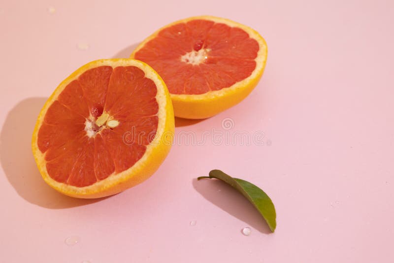 Halved Grapefruit on a Pink Background Stock Image - Image of halved ...