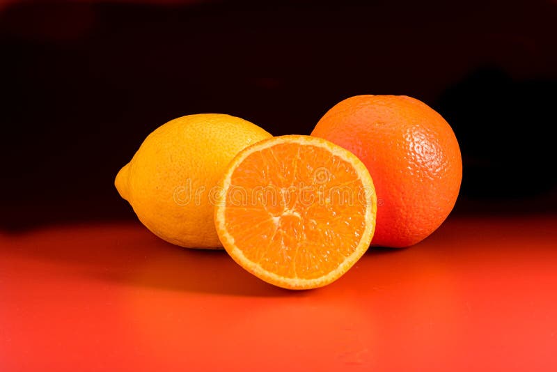 Halved Orange Facing the Camera Leaning on Whole Lemon and Orange on ...