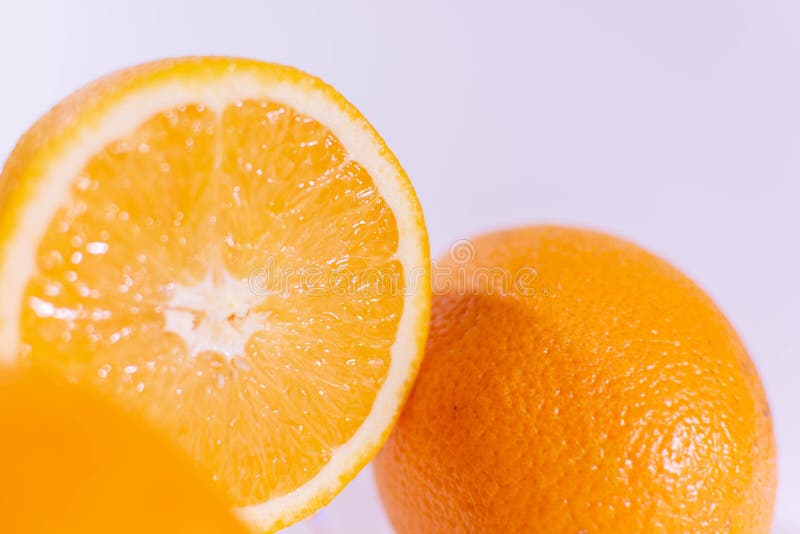 Halved Orange Near a Whole Orange on a White Background Stock Photo ...