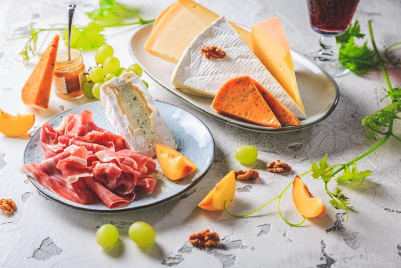 Ham and Cheese Platter with Grapes, Nuts and Red Wine Stock Photo ...