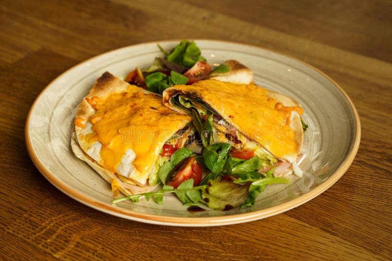 Ham and Cheese Tortilla Sandwich with Vegetables on a Wooden Table ...