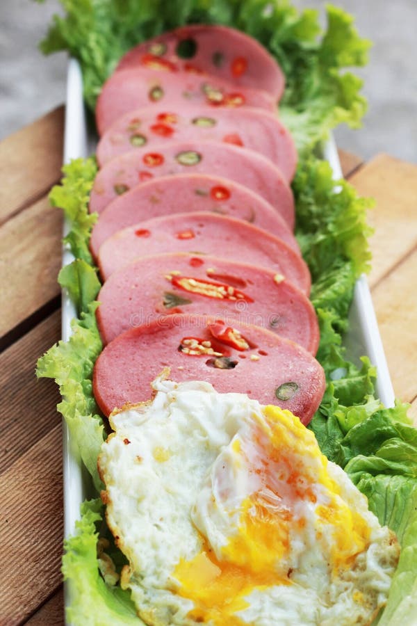 Ham Cut into Circular Discs with Red Peppers and Egg Fried. Stock Image ...