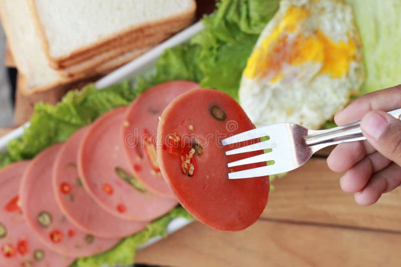 Ham Cut into Circular Discs with Red Peppers and Egg Fried. Stock Photo ...