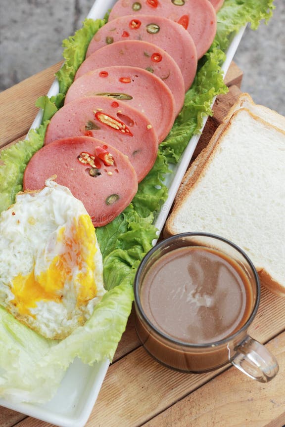 Ham Cut into Circular Discs with Red Peppers and Hot Coffee Stock Photo ...