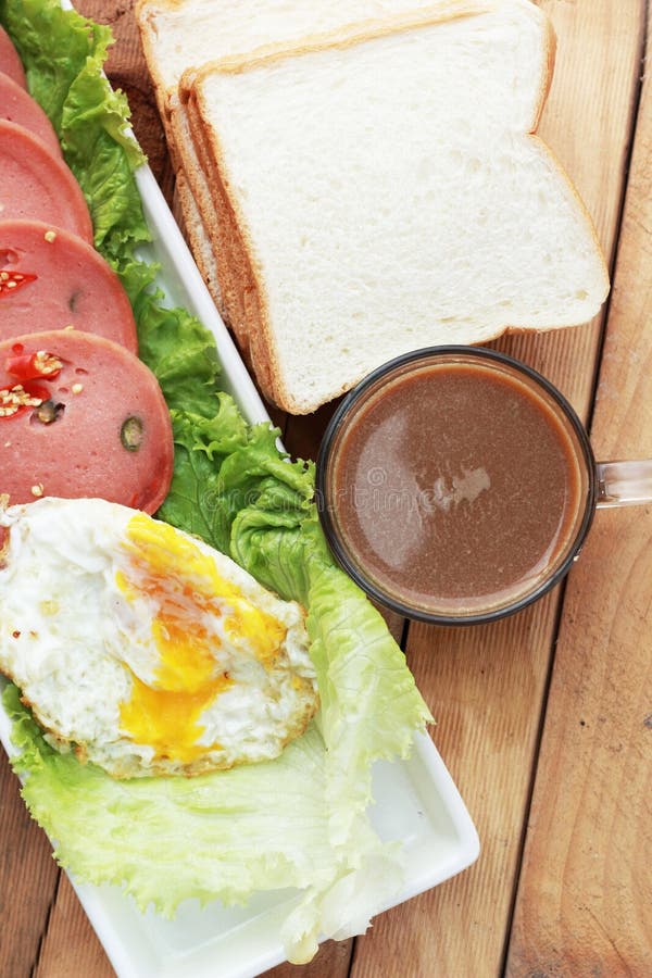 Ham Cut into Circular Discs with Red Peppers and Egg Fried. Stock Image ...