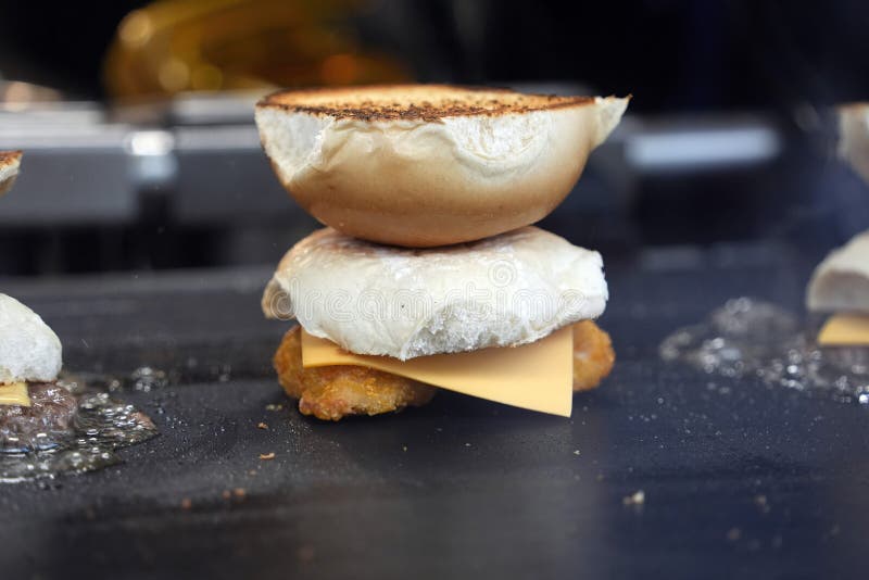 Hamburger Being Prepared on a Moving Hot Plate Stock Image - Image of ...