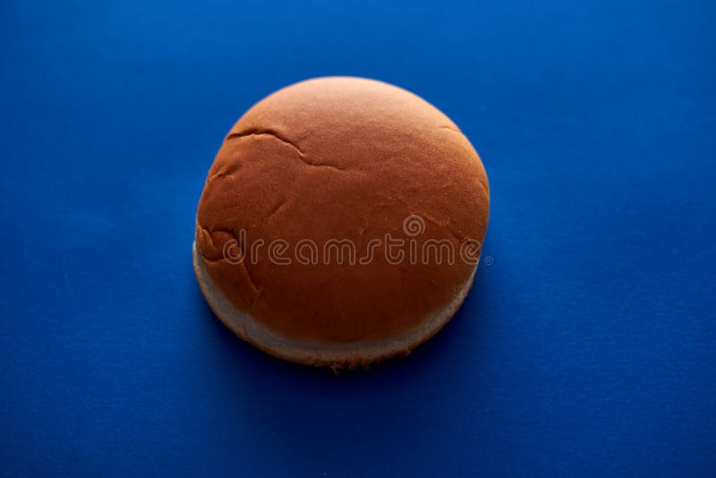 Hamburger Bun on a Blue Background Stock Photo - Image of sandwich ...