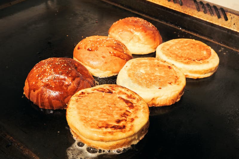 Hamburger or Burger Buns on the Grill Stock Photo - Image of bakery ...