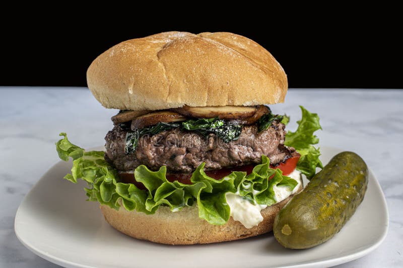 Hamburger Top with Sauteed Spinach and Mushrooms Stock Photo - Image of ...