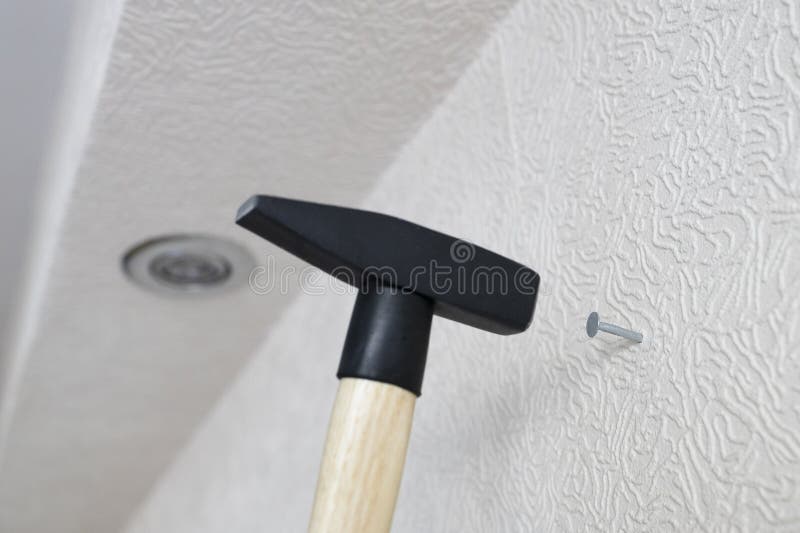 Hammer Hammers Nail into White Wall Stock Image - Image of steel, urban ...