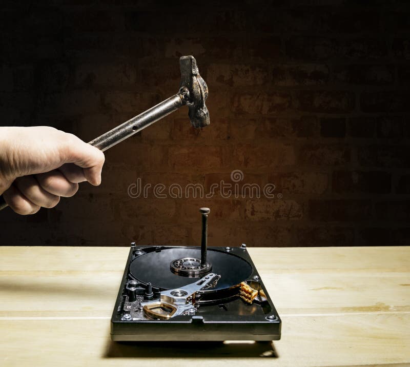 A Hammer Hits a Nail into the Hard Drive from the Computer Stock Photo ...