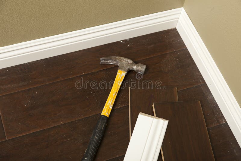 Hammer, Laminate Flooring and New Baseboard Molding Stock Image - Image ...