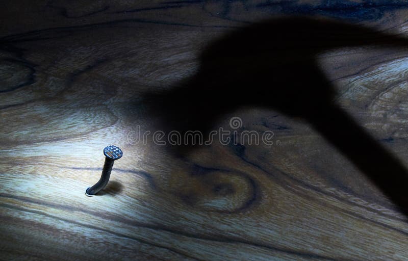 Hammer and Nail. the Shadow of the Hammer Hammers a Nail into the Board ...