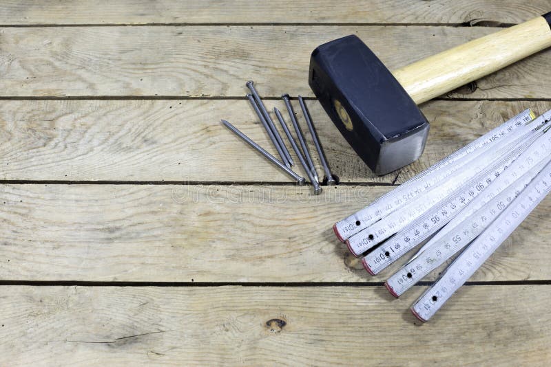 Hammer, Nails and Folding Ruler on Wooden Plank Stock Image - Image of ...