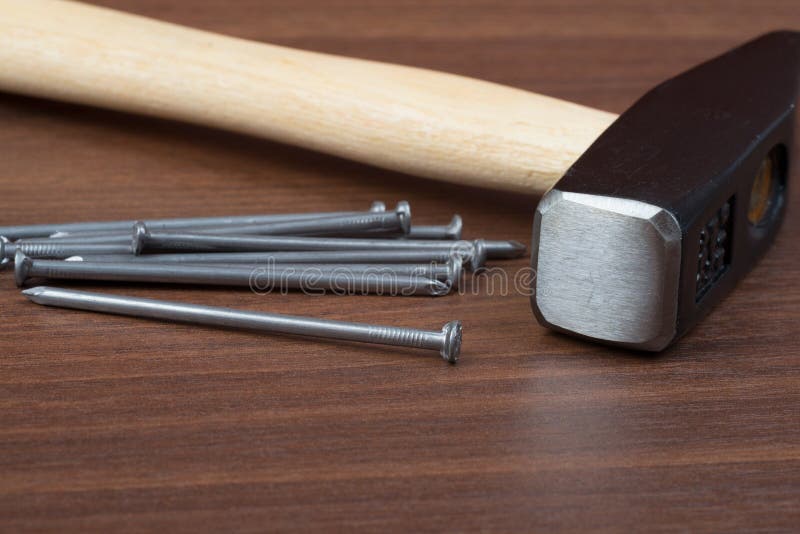 Hammer and nails on table stock photo. Image of table - 55375496
