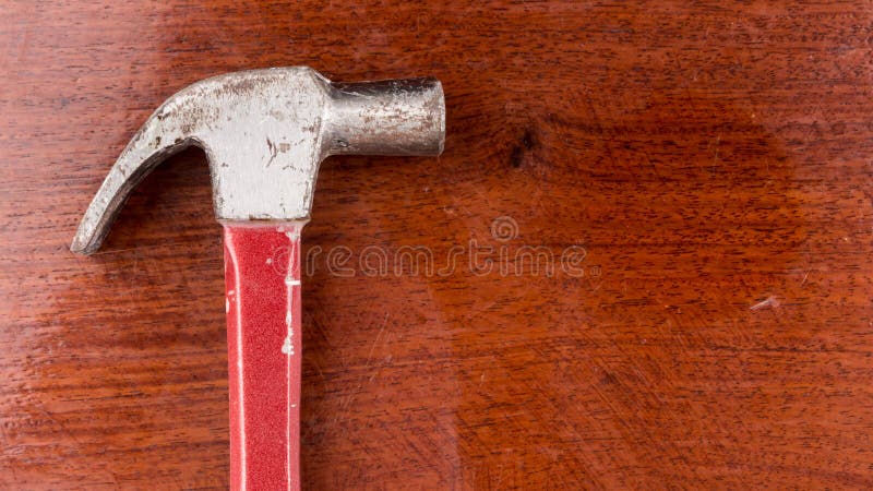 Hammer on wooden table stock image. Image of instrument - 61789733