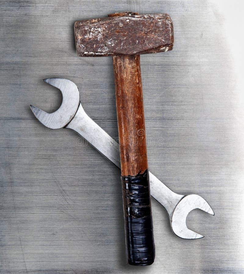 Hammer and wrench on metal stock photo. Image of isolated - 33800634
