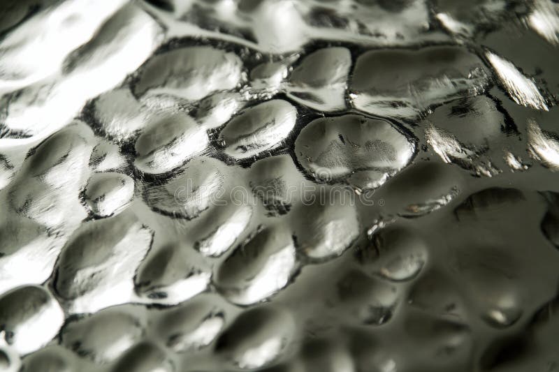 A Hammered Silver Surface with Irregular Dimples and a Reflective Sheen ...