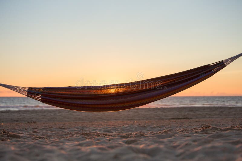 Hammock in sunset at beach stock image. Image of silhouette - 48804793