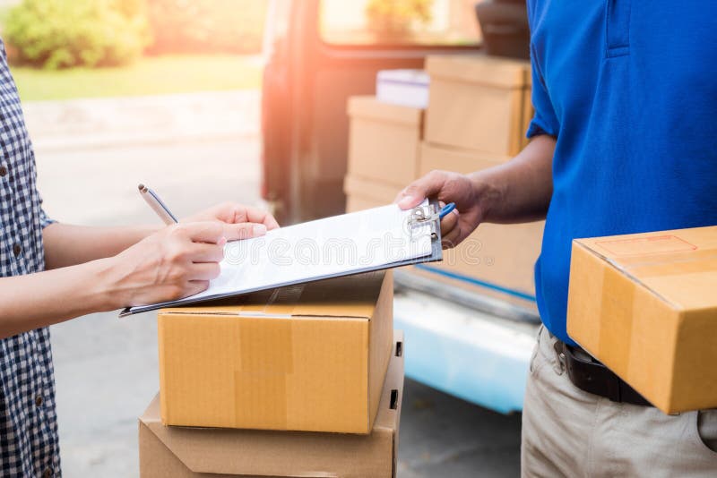 Hand Accepting a Delivery of Boxes from Deliveryman. Stock Photo ...
