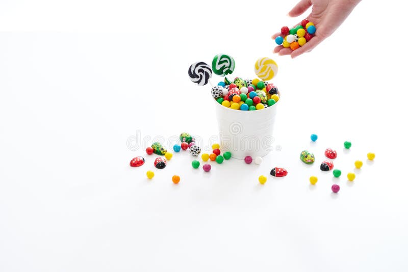 Hand Adding Candy To Bucket Stock Image - Image of pail, hand: 59856393