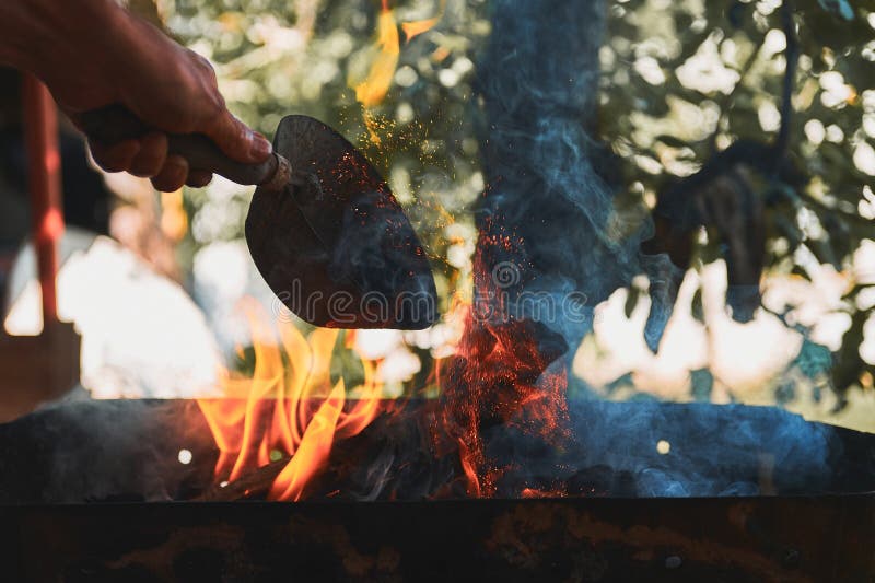 Hand Adding Coil on Grill Fire Stock Image - Image of preparing, making ...