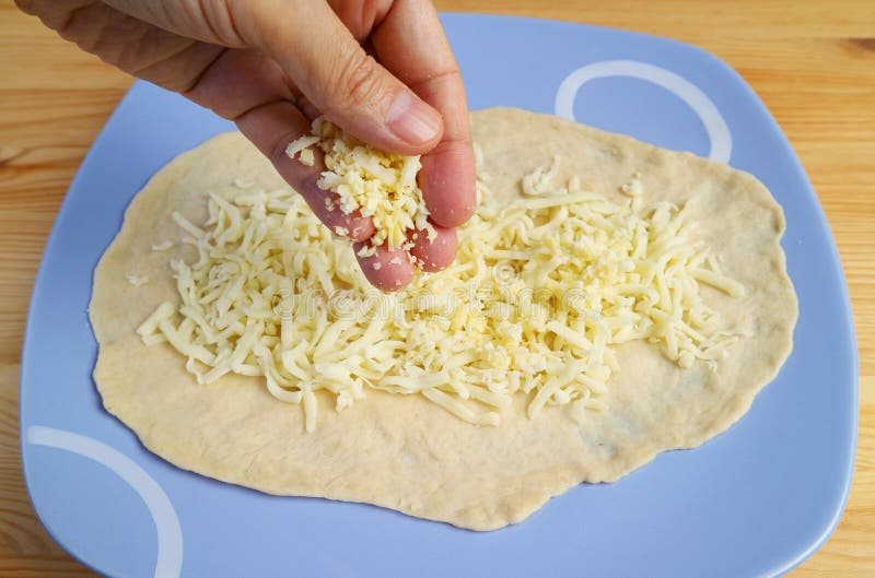 Hand Adding Cheese Onto the Dough before Baking Stock Image - Image of ...