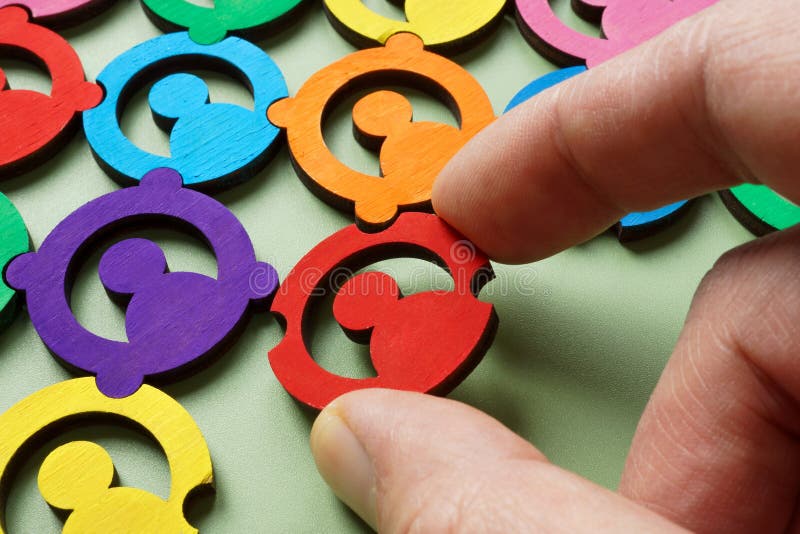 A Hand Adding Piece To a Colorful Puzzle. Diversity and Team ...