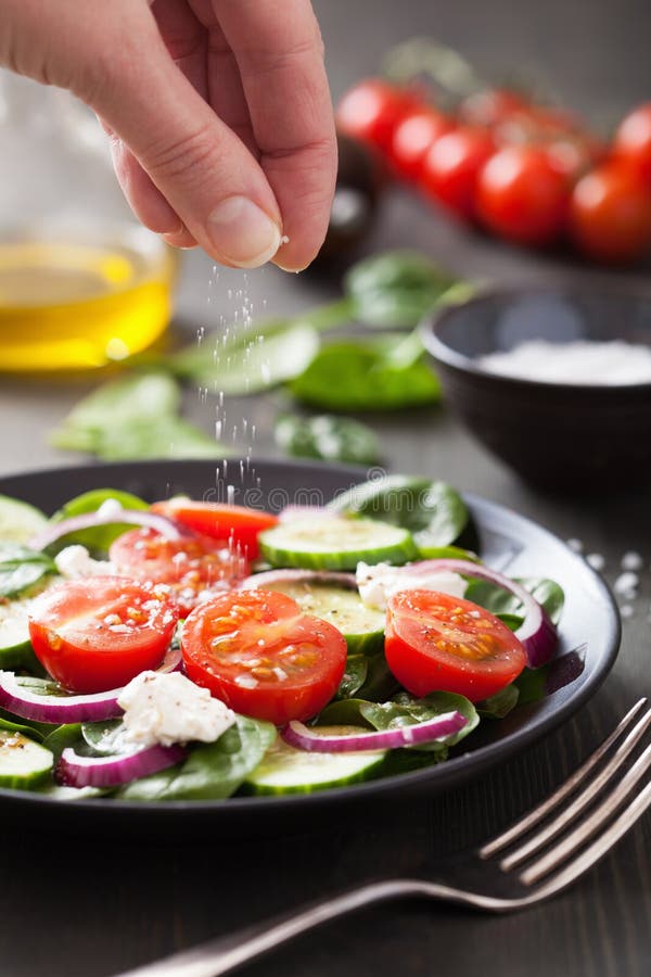 Hand Adding Salt To Vegetable Salad Stock Photo - Image of herb ...