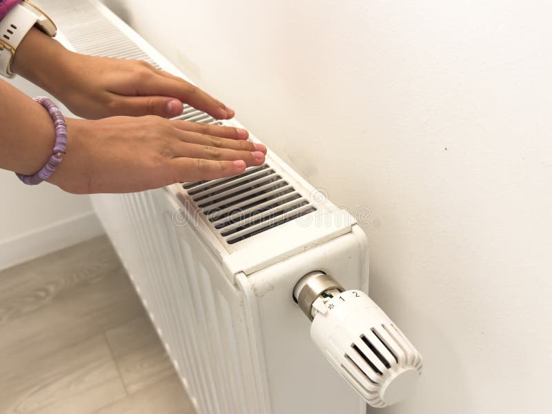 Hand Adjusting Radiator Temperature Using Thermostat. Home with Central ...