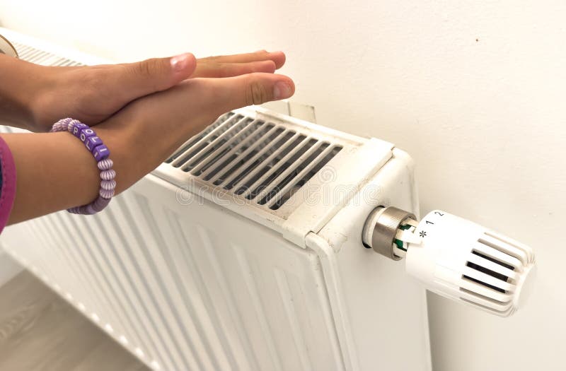 Hand Adjusting Radiator Temperature Using Thermostat. Home with Central ...