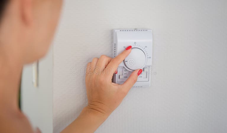 Hand Adjusts Button of the Control Unit of Heating and Cooling System ...