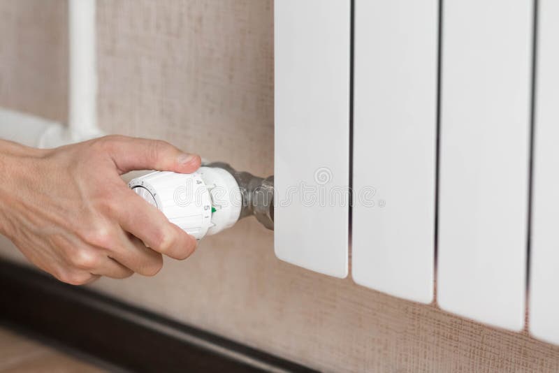The Hand Adjusts the Radiator. Closeup Stock Image - Image of closeup ...