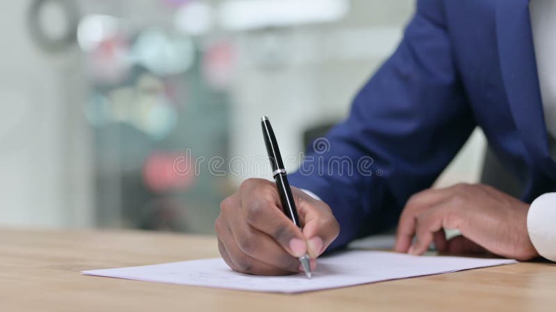 African Man Writing Letter at Work Paperwork Stock Video - Video of ...