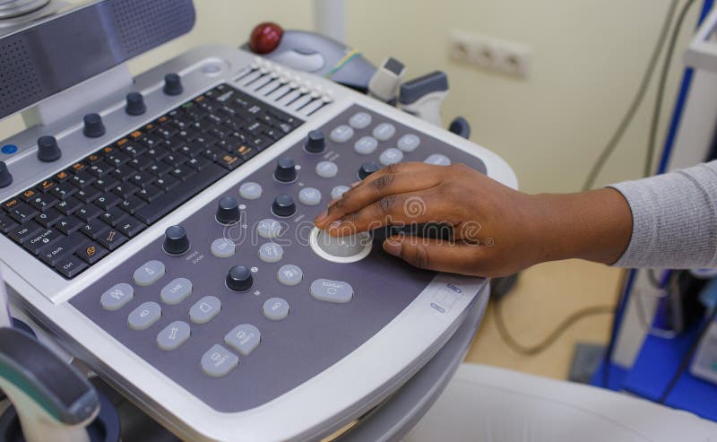 The Hand of an African Doctor Lies on the Control Panel of an ...