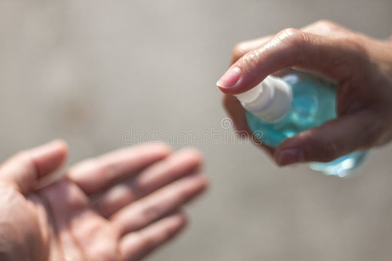 Hand with alcohol spray stock photo. Image of safeathome - 213257950