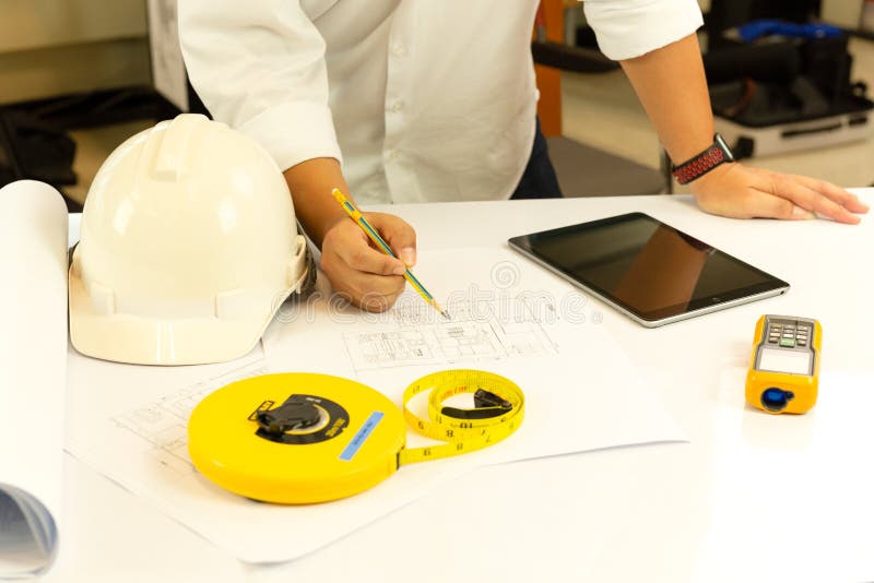 Hand of Architect Working on Blueprint with Tablet Computer on Table ...