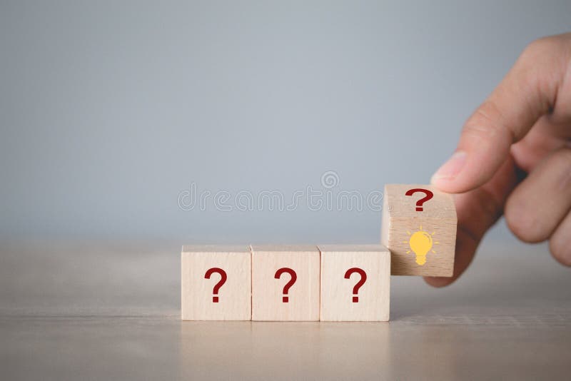 Hand Arranging Wood Block Stacking with Icon Question Mark and Lamp ...