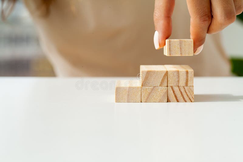 Hand Arranging Wood Cube Stacking As Stair Step Shape Stock Photo ...